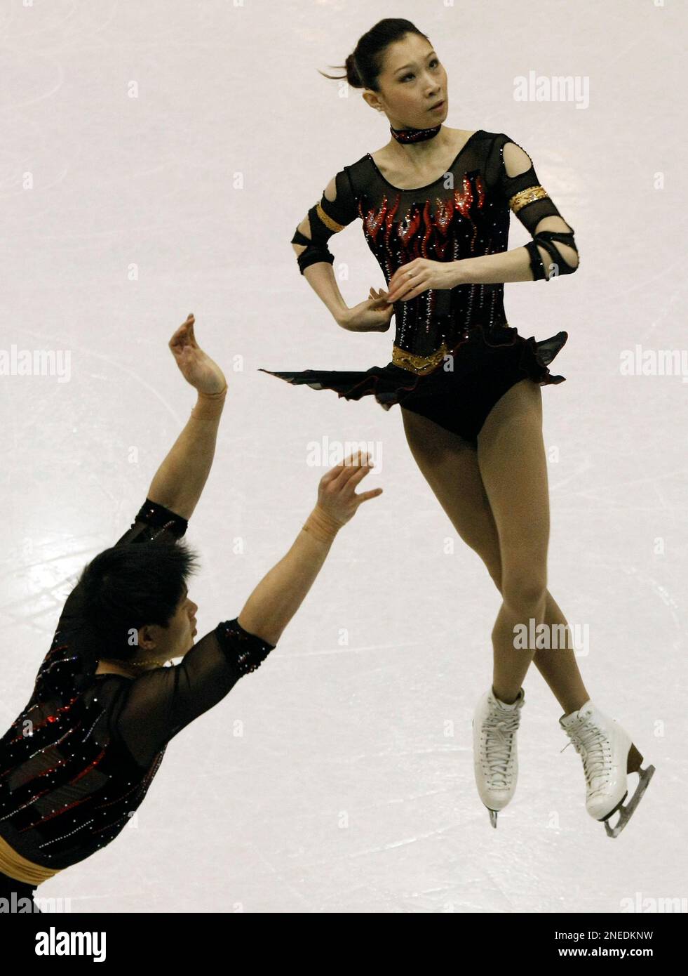 China's Dan Zang and Hao Zhang, left, perform in the pairs free skating ...