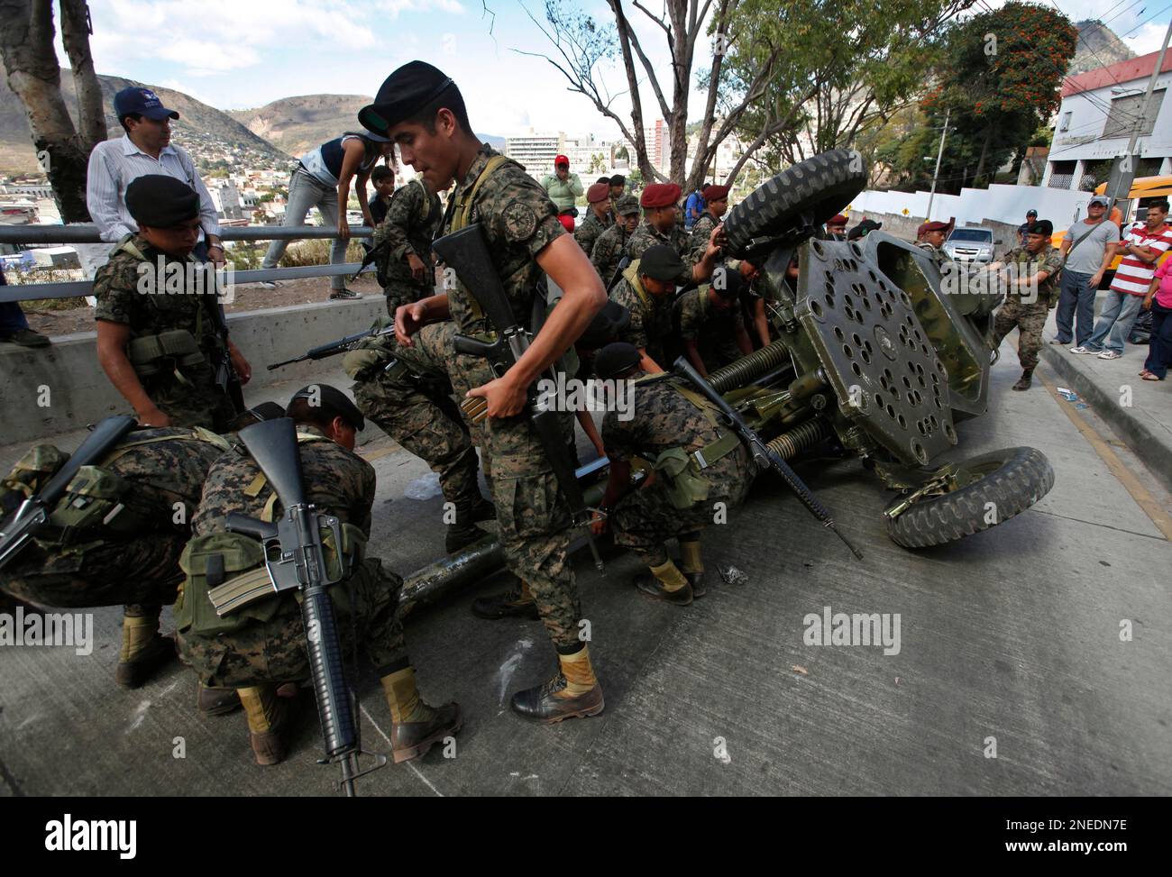 Honduras Army soldiers help to flip a canon on it's right side during ...