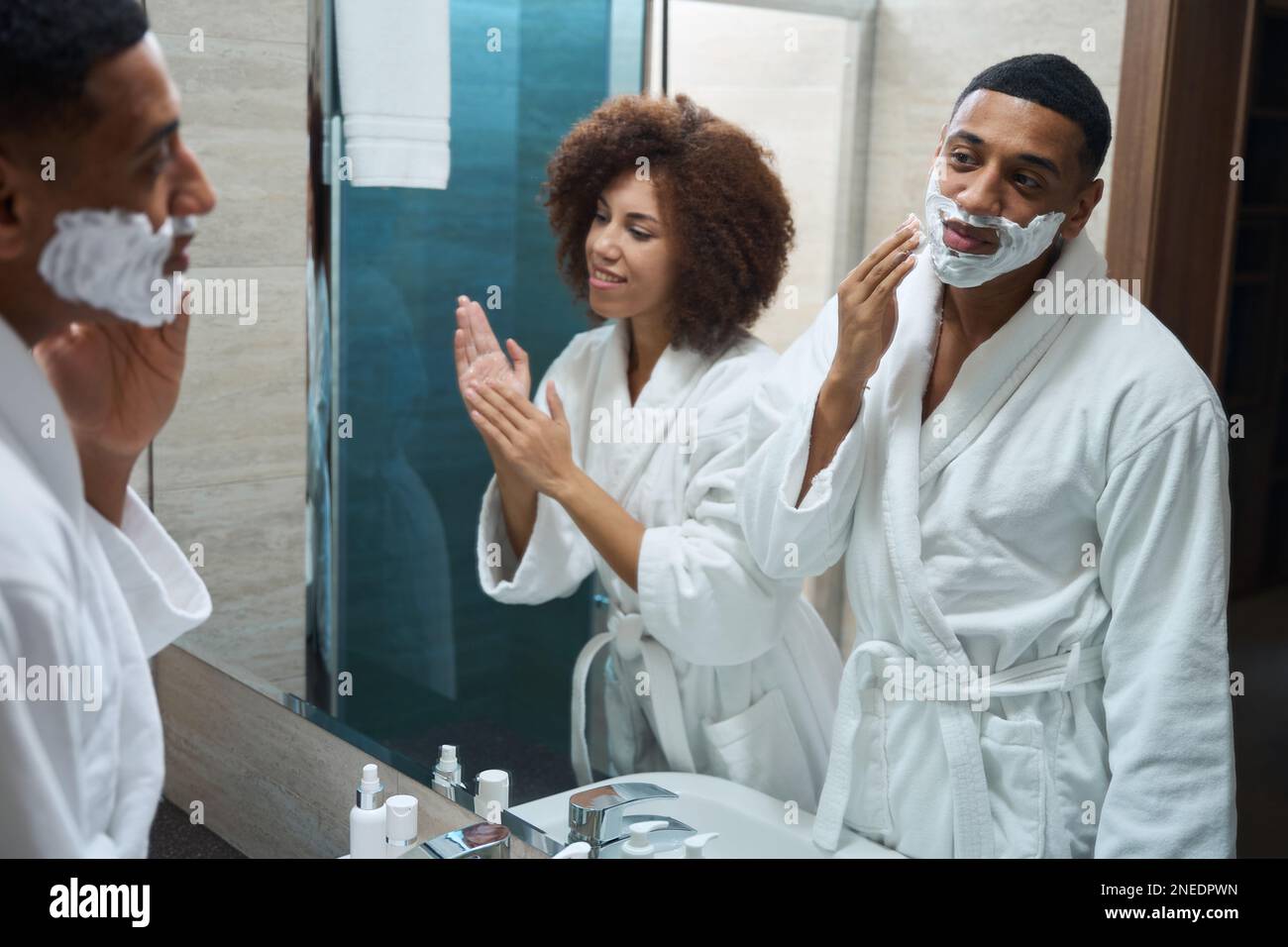 Man and woman doing morning routine in hotel bathroom Stock Photo - Alamy