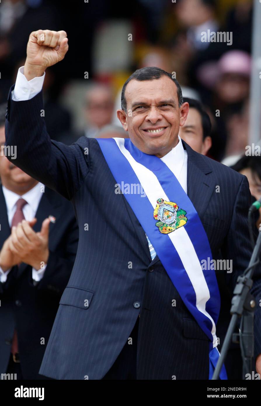 Wearing the presidential sash, Honduras' President Porfirio Lobo, waves ...