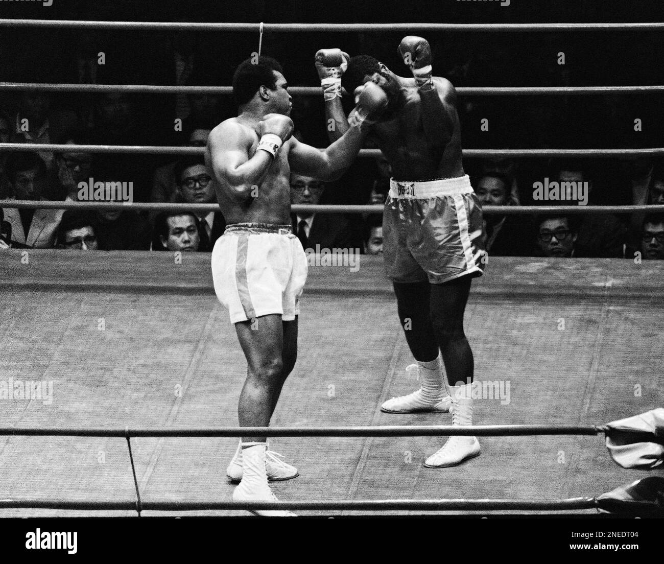 A left swing by Muhammad Ali glances off the face of Bob Foster in ...