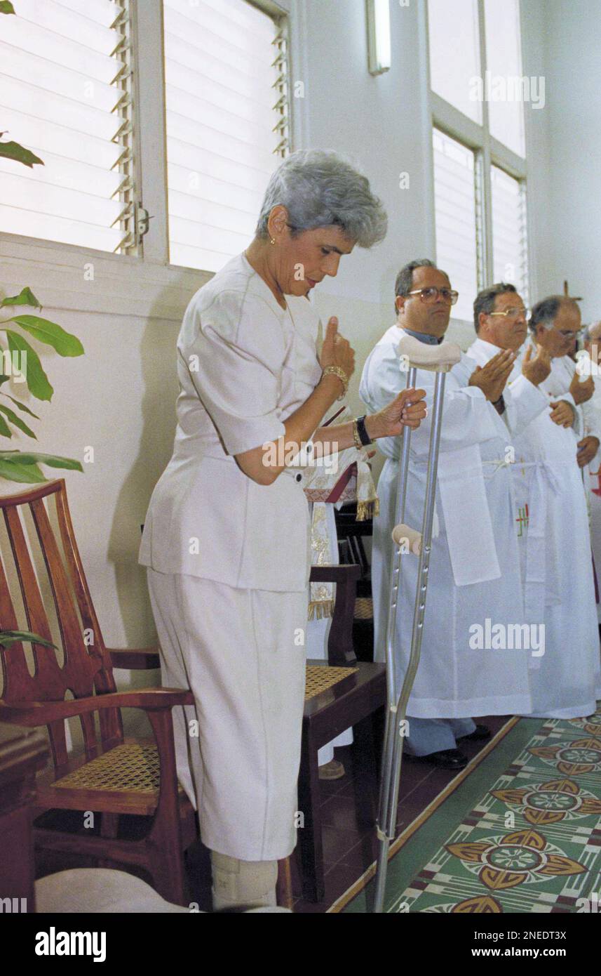 Violeta Barrios De Chamorro makes the sign of the cross as she cross as ...