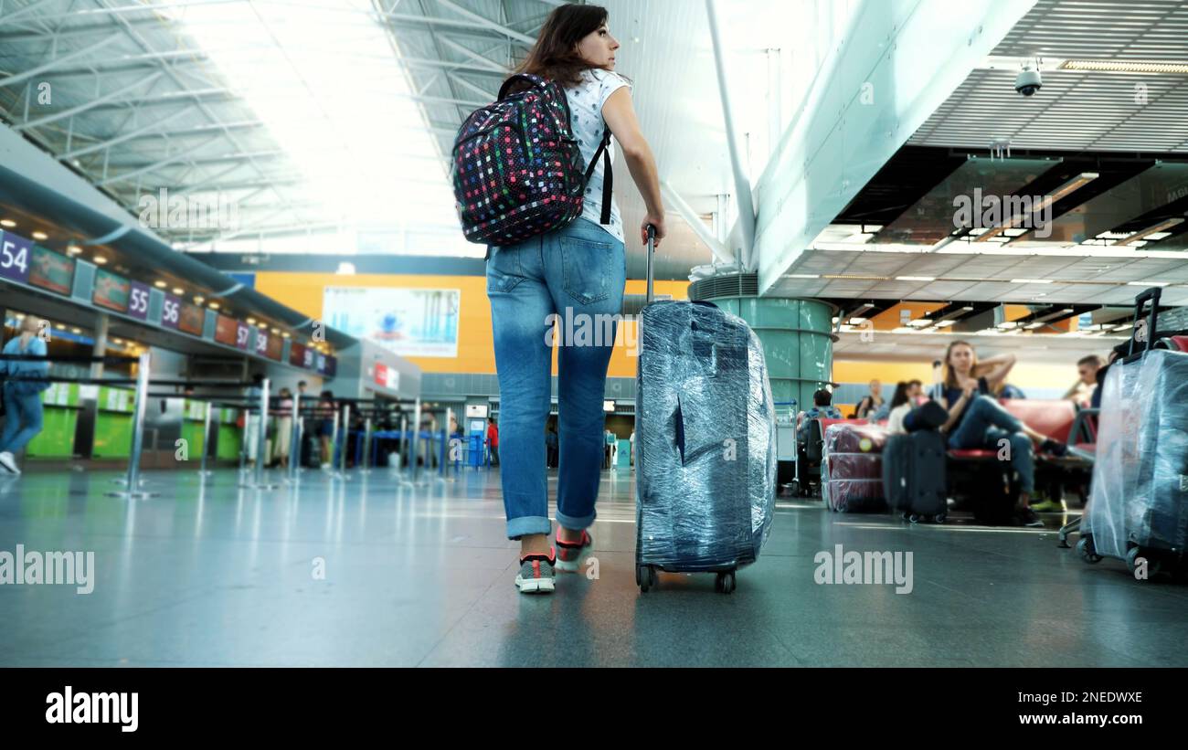 people at the airport's public check-in counter. Waiting lines in the ...
