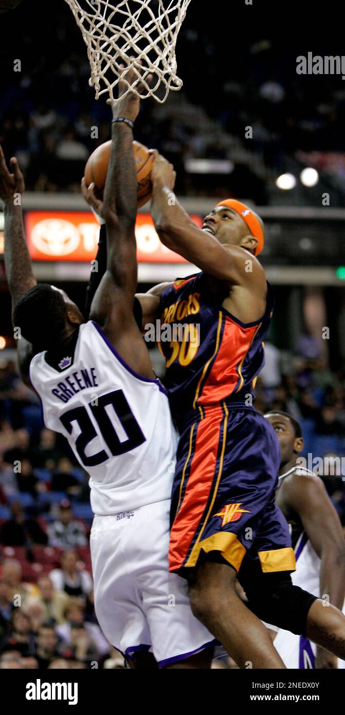 Golden State Warriors forward Corey Maggette, right, goes to the basket ...