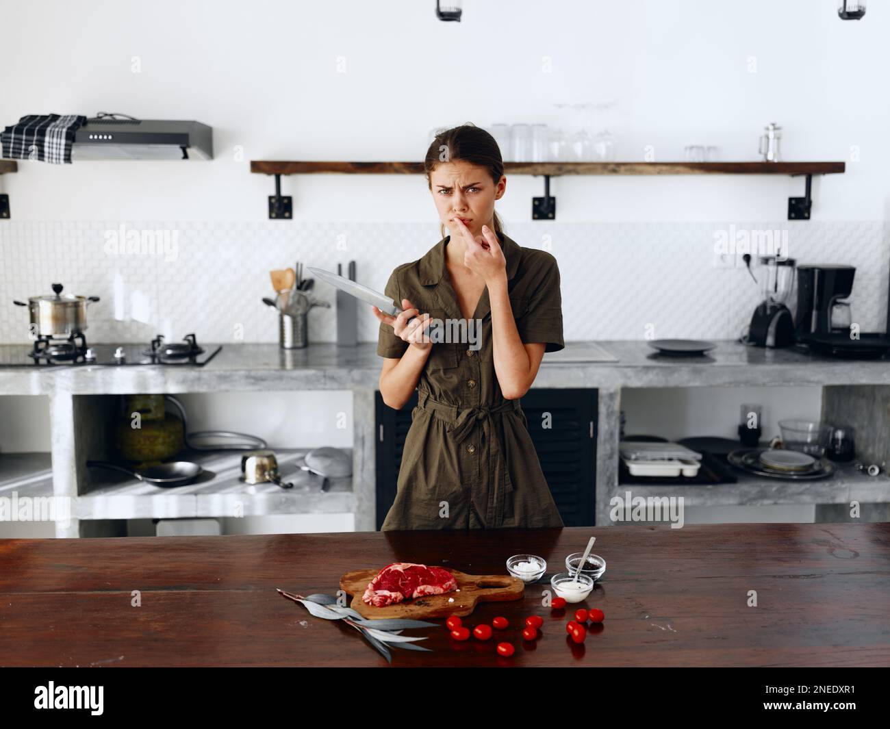 Sad angry woman standing in Stylish minimalist kitchen interior with ...