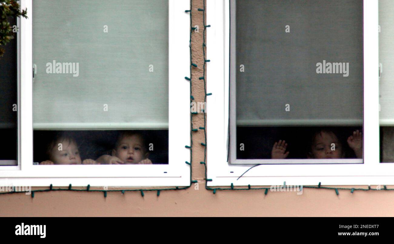 Unidentified children peer from a window in Nadya Suleman's home on the ...