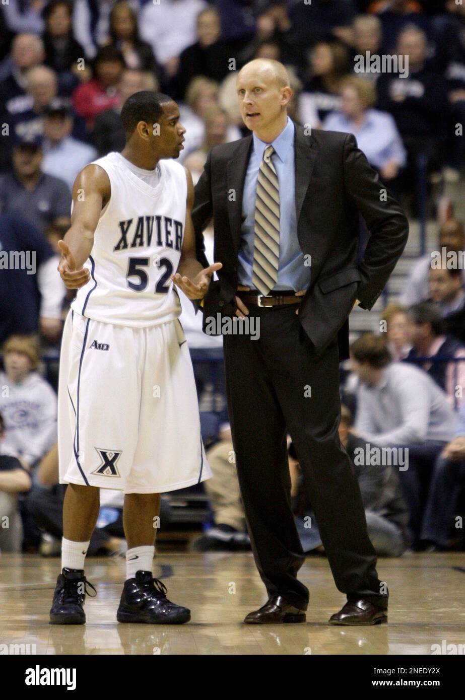 Xavier head coach Chris Mack talks with Xavier guard Terrell Holloway ...