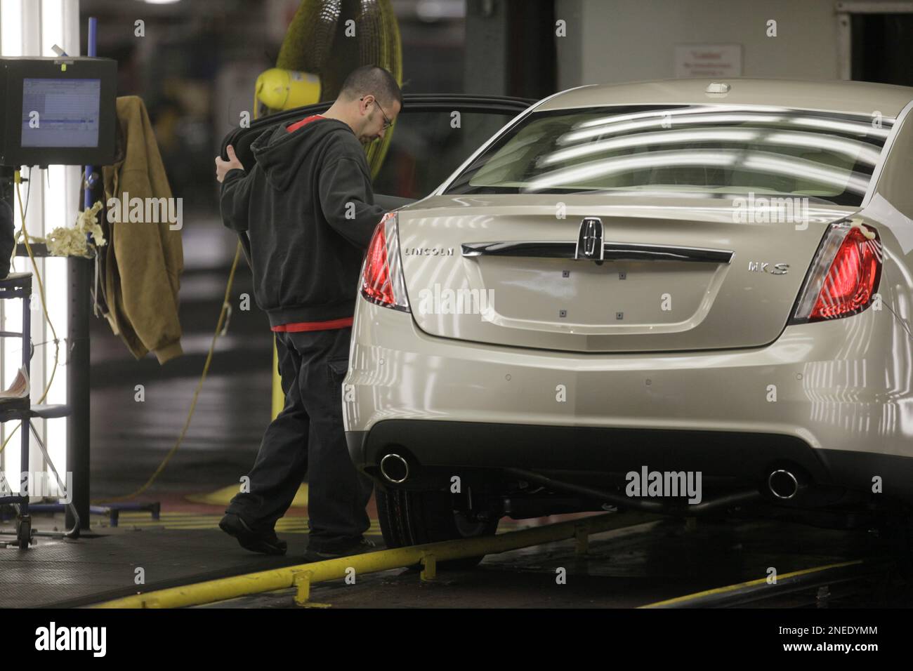 Workers man the assembly line of Ford Motor Co.'s Chicago Assembly ...
