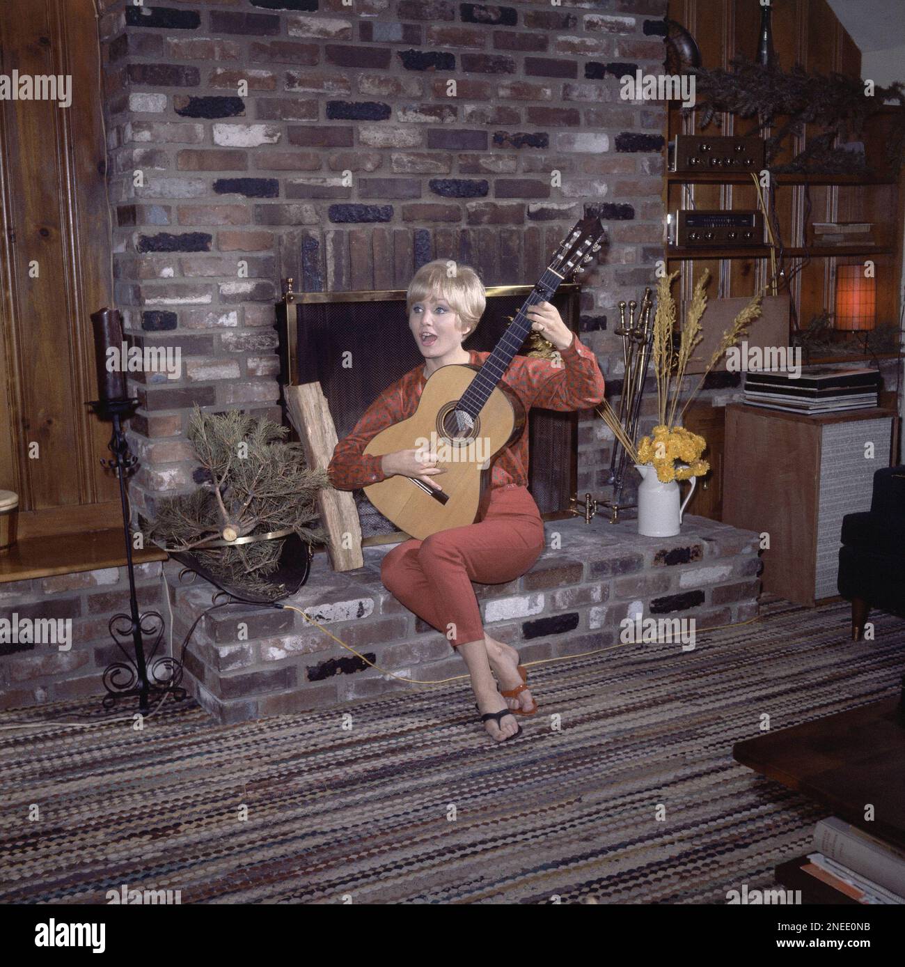 Actress Susan Oliver is plays the guitar and sings at her home in ...