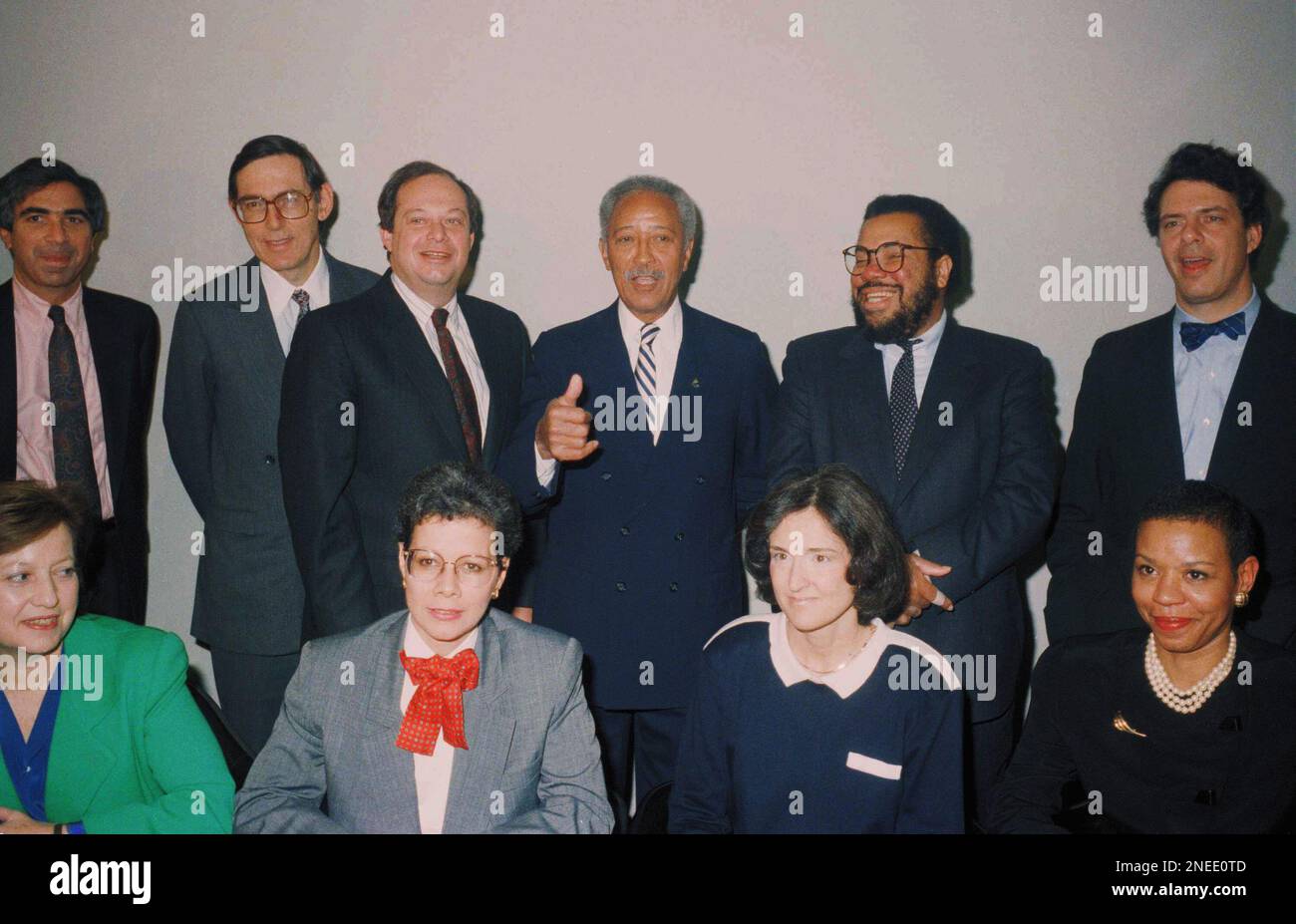 New York Mayor-elect David Dinkins, center rear, gestures while posing ...