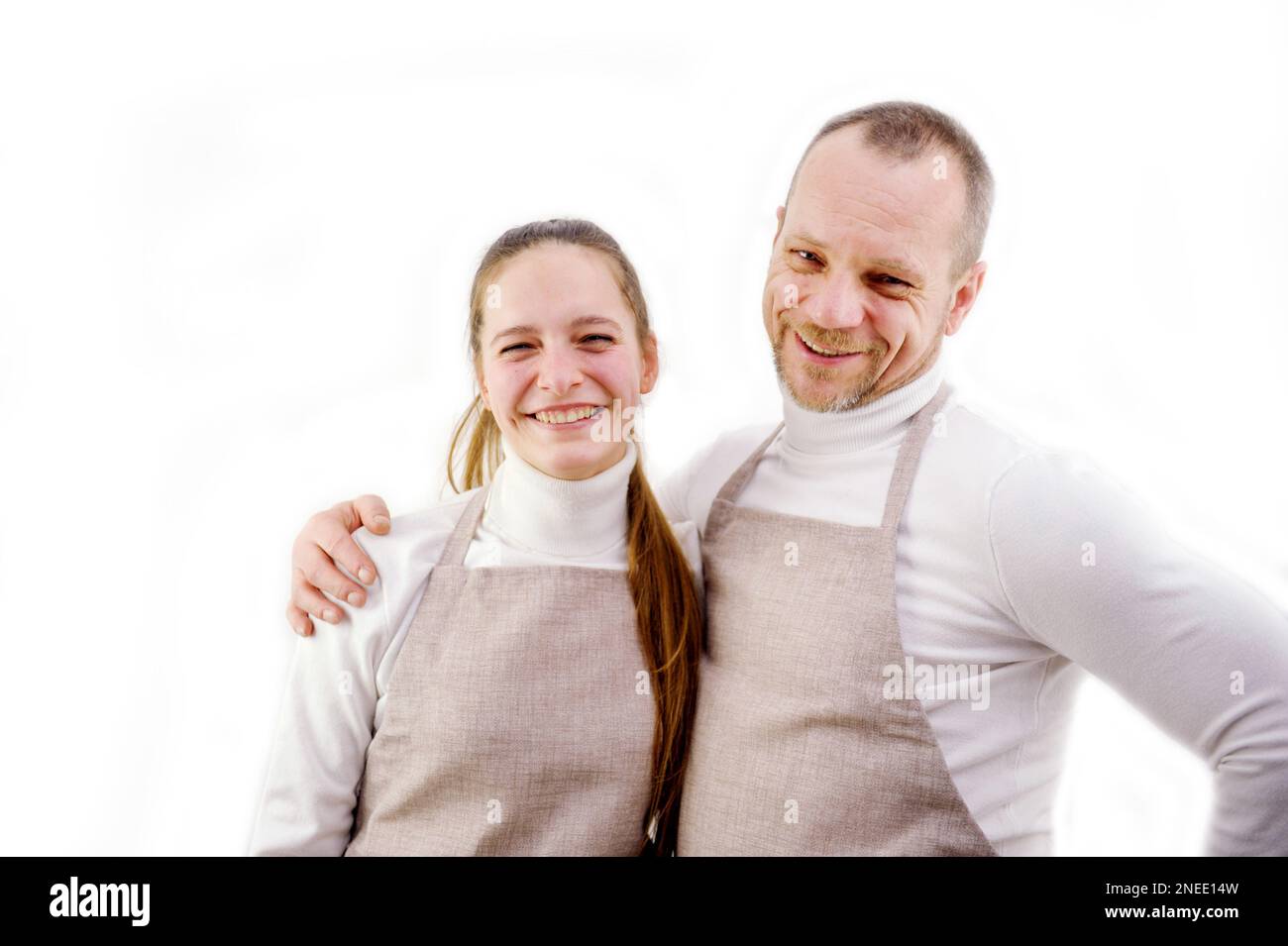 master and apprentice smile and look into frame chef and assistant ...