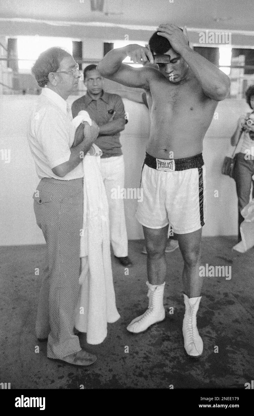 Muhammad Ali combs his hair after working out at N?Sele, Zaire, Oct. 23 ...