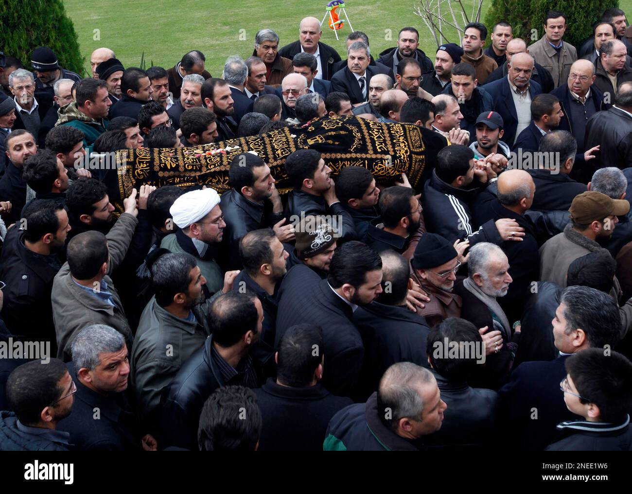 Mourners carry the coffin of prominent businessman Hassan Tajeddine a ...