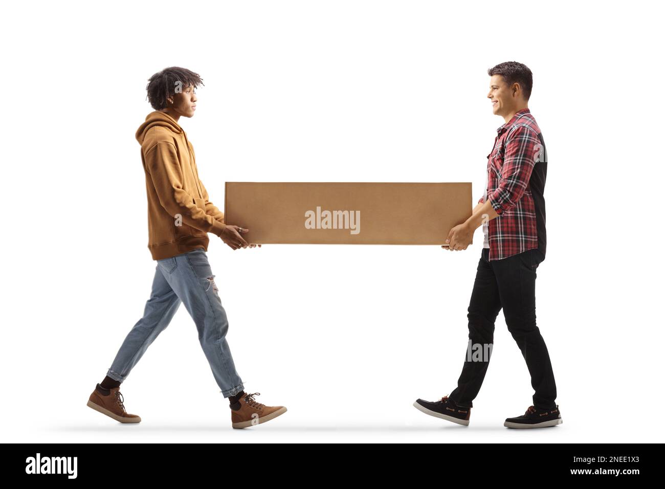 Caucasian and african american guy carrying a cardboard box together ...