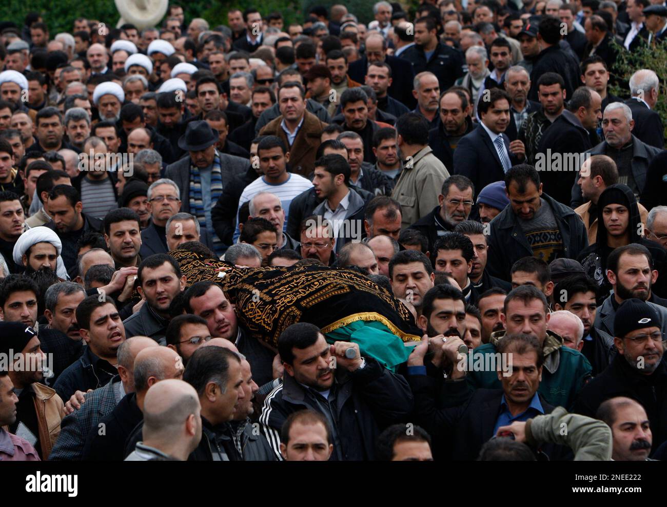 Mourners carry the coffin of prominent businessman Hassan Tajeddine a ...