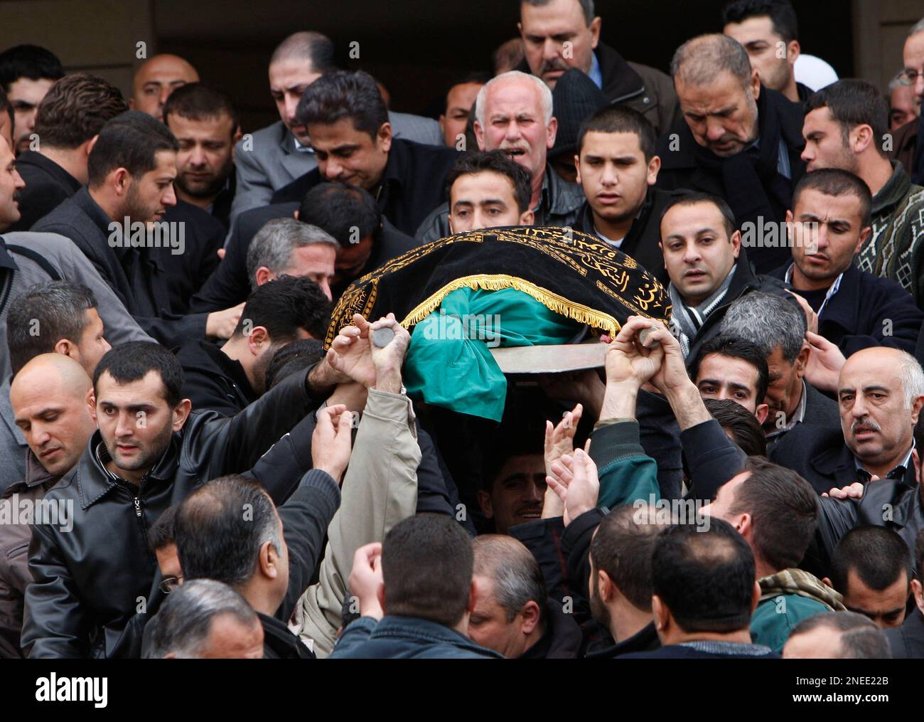 Mourners carry the coffin of prominent businessman Hassan Tajeddine a ...