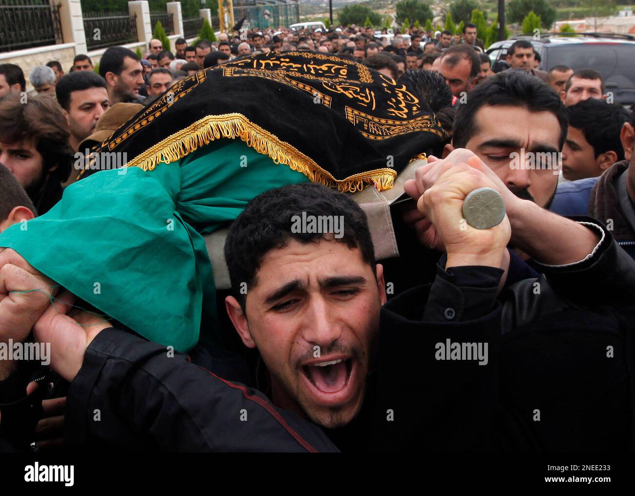 Mourners carry the coffin of prominent businessman Hassan Tajeddine a ...