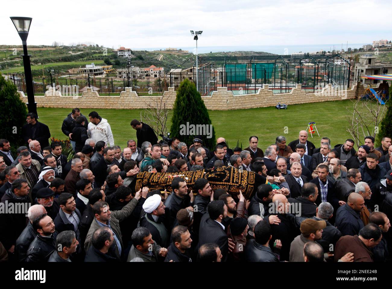 Mourners carry the coffin of prominent businessman Hassan Tajeddine a ...