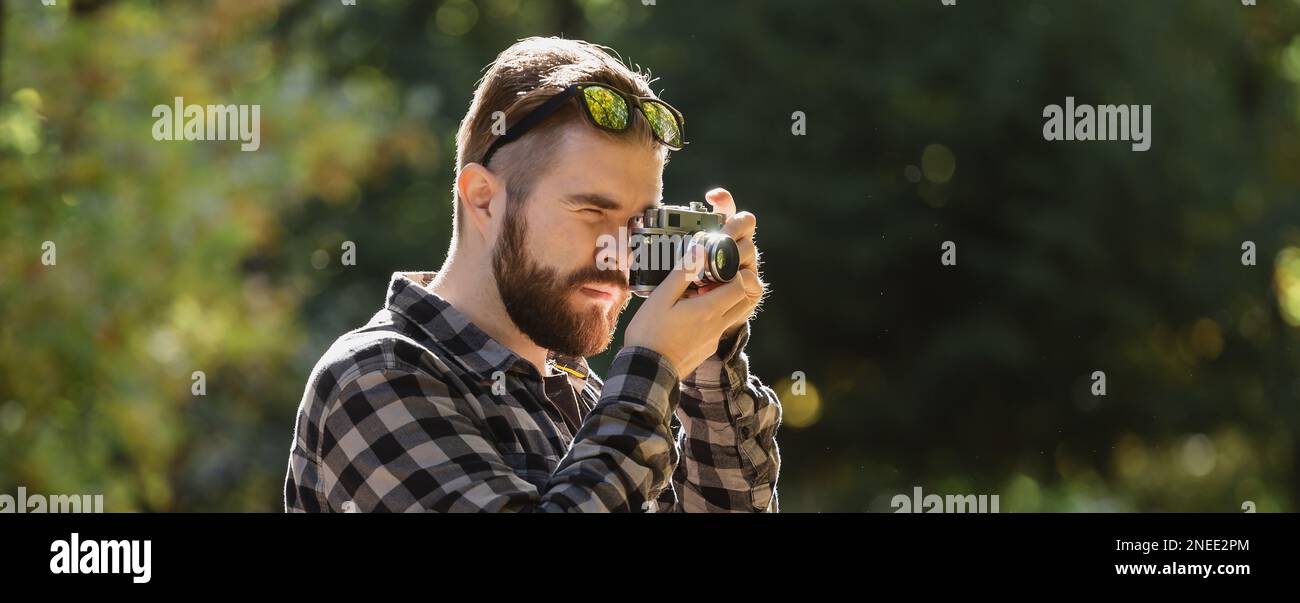 Banner Portrait man photographer taking picture with vintage camera on ...