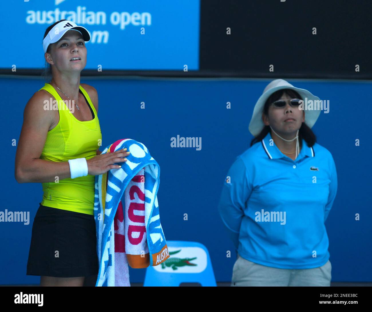Russia's Maria Kirilenko stands alongside line judge Shino Tsurubuchi ...