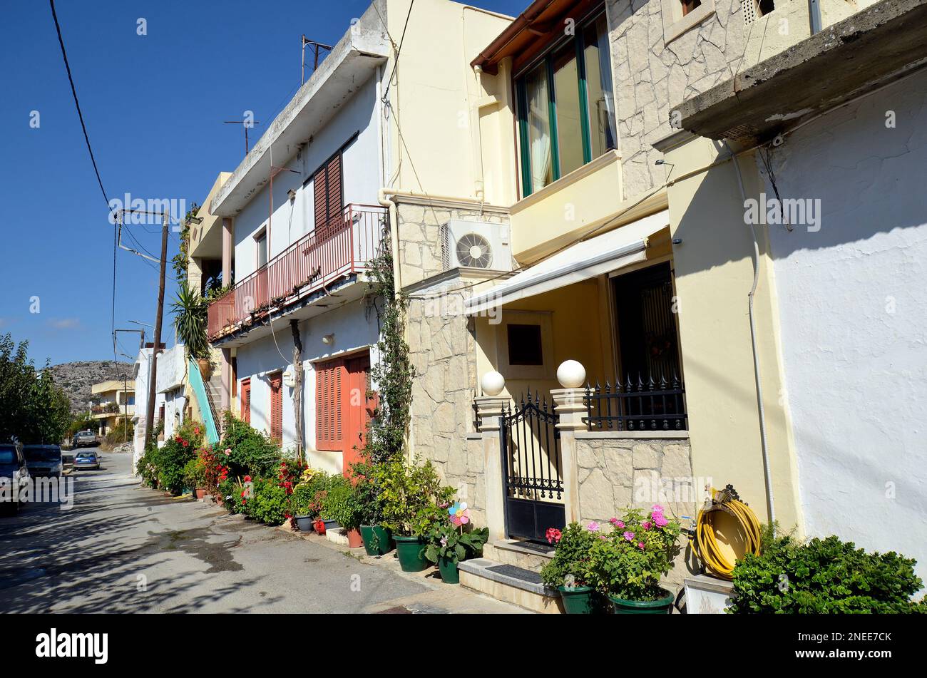 Greece, Crete, narrow street and house front decorated with flowers in ...