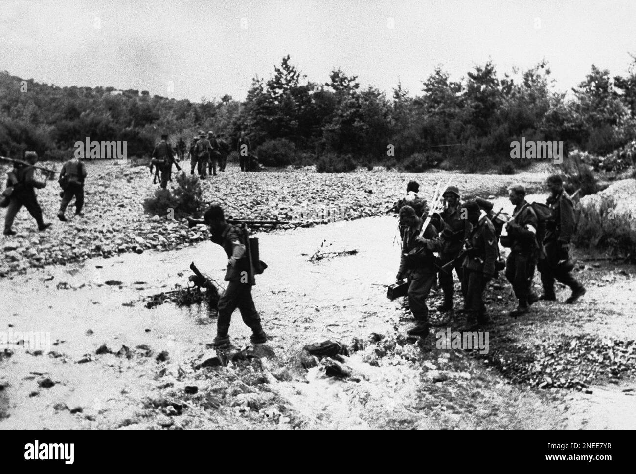 German alpine troops crossing a brook during their advance in Crete ...