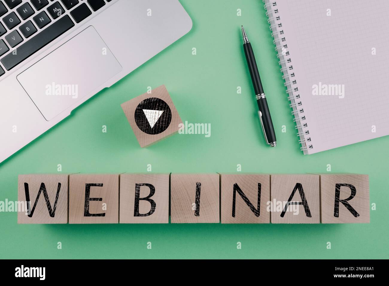 word WEBINAR and play button symbol on wood cubes against green ...