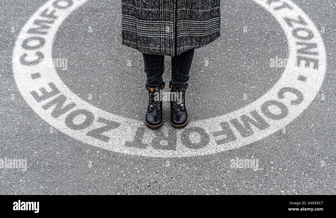 high angle view of legs of woman about to leave circular marking on ...