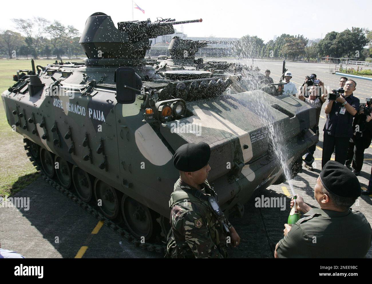 A Philippine military officer sprinkles champagne on newly acquired ...