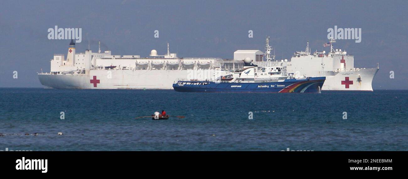 The Greenpeace ship Esperanza sits in front of the USNS Comfort as they ...