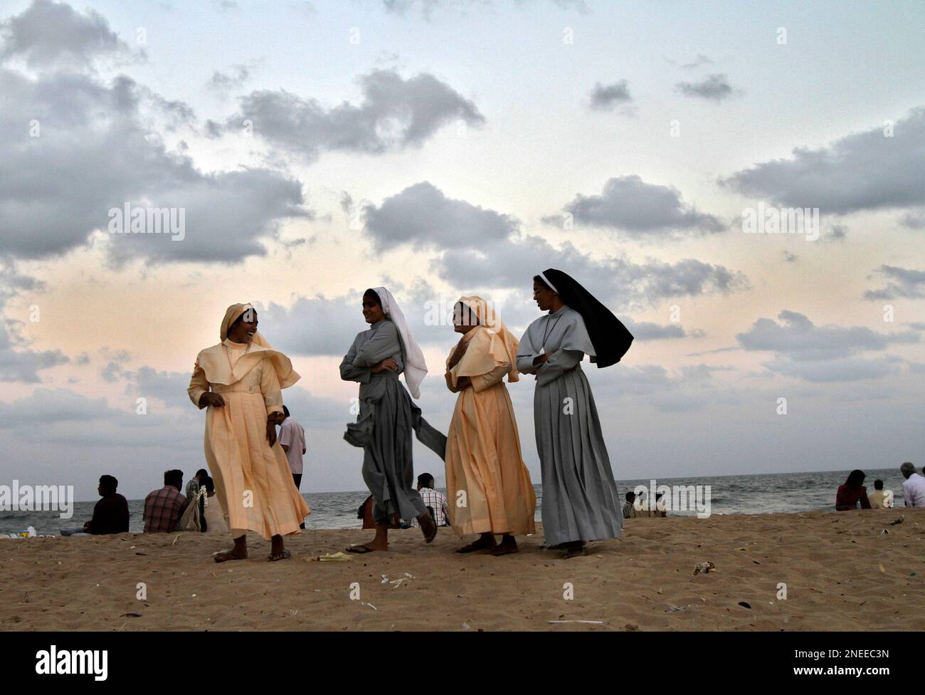 Christian nuns walk on a beach in Chennai, India, Sunday, Jan. 24, 2010 ...