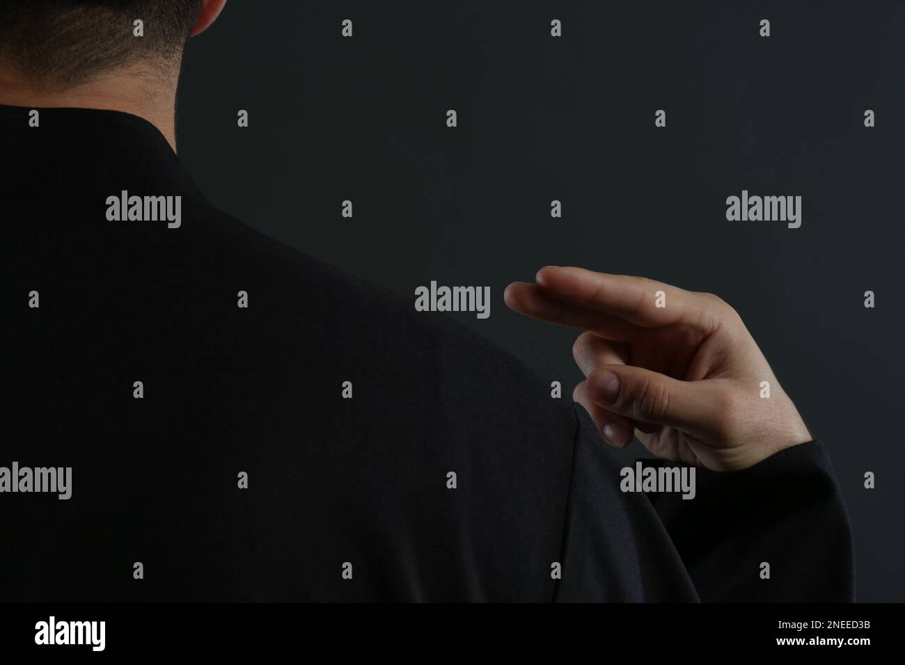 Priest making cross sign on black background, closeup Stock Photo - Alamy