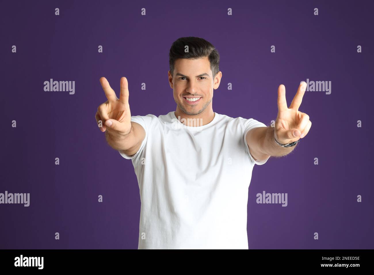 Man showing number four with his hands on purple background Stock Photo ...