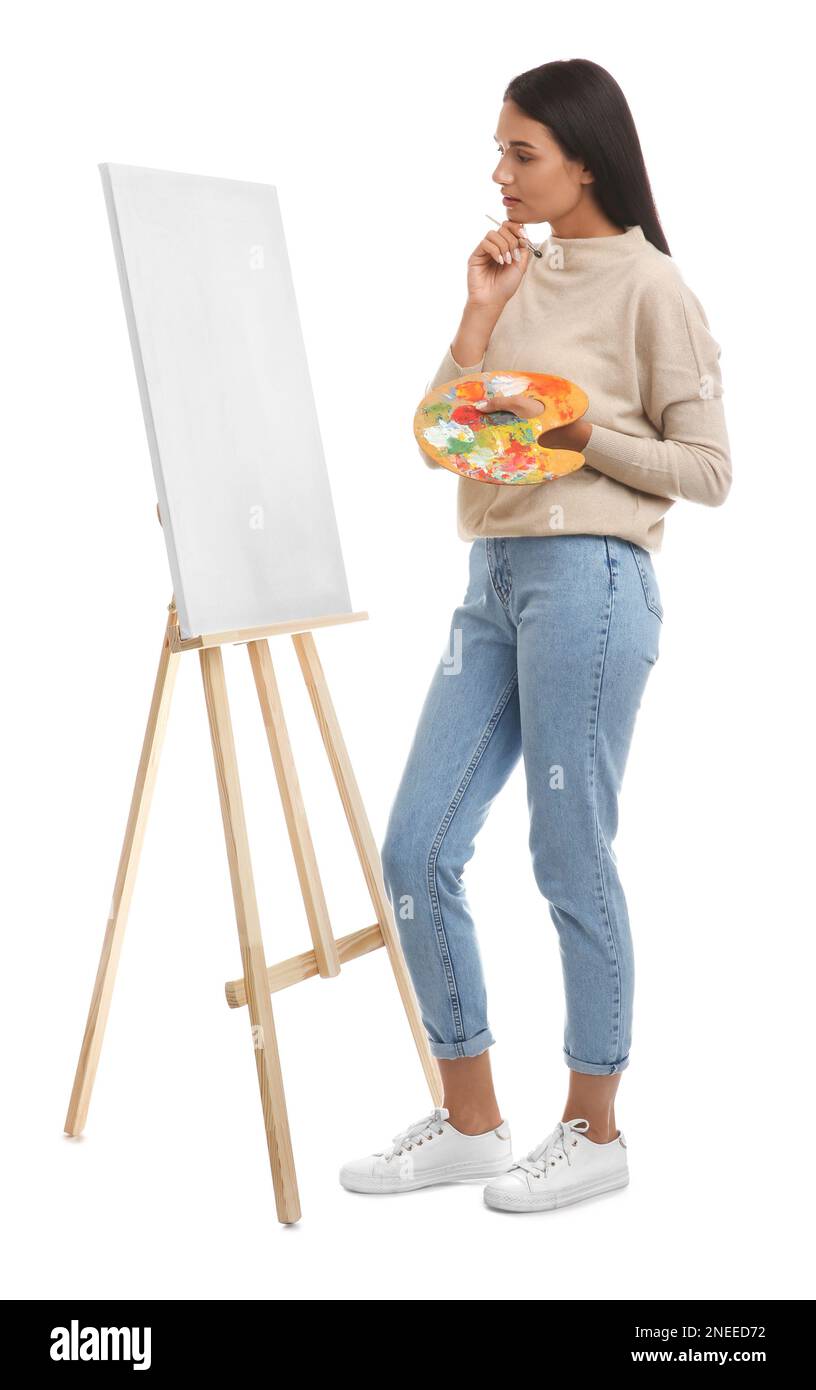 Young woman drawing on easel against white background Stock Photo - Alamy