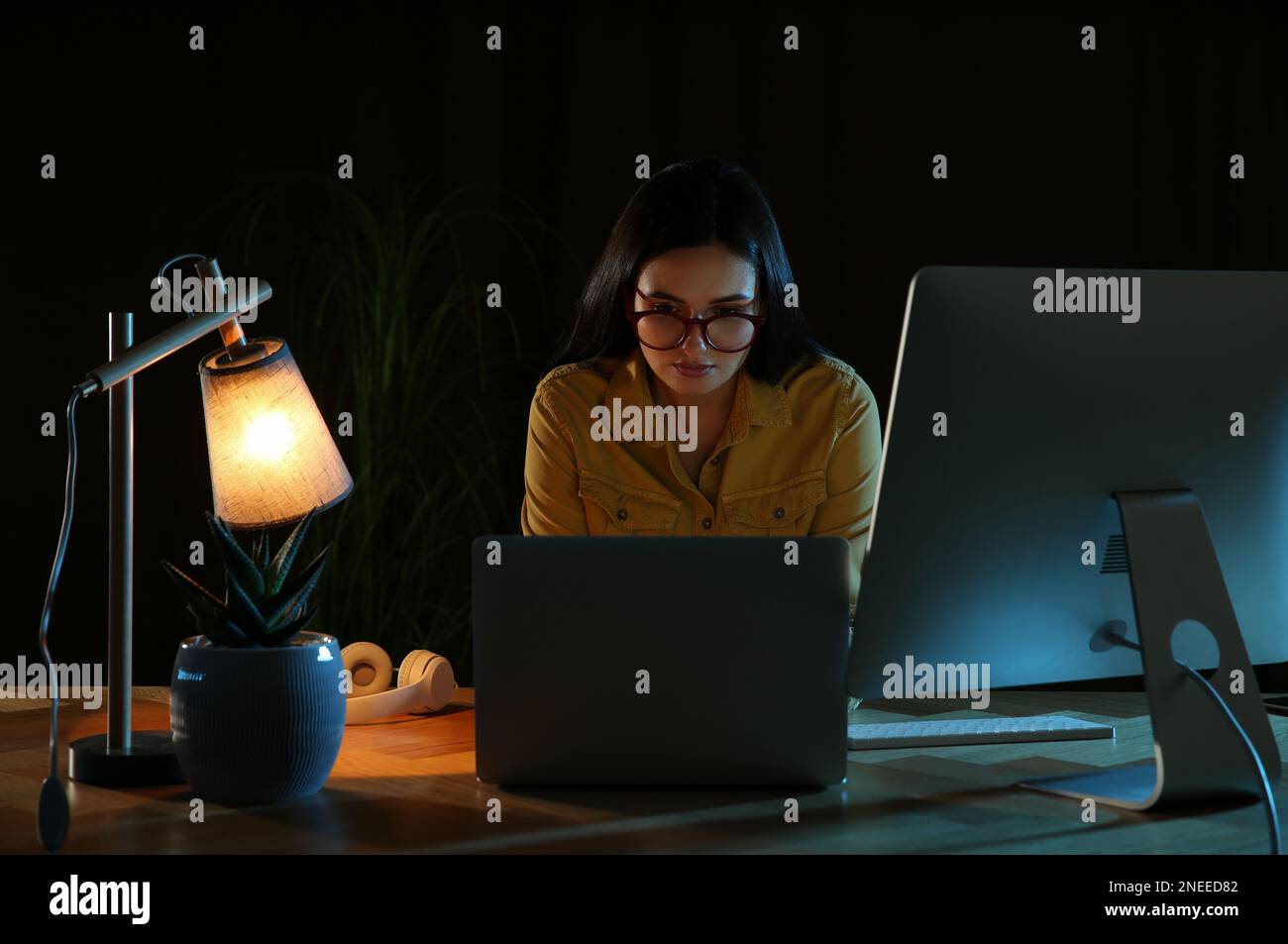 Programmer working in modern office at night Stock Photo - Alamy