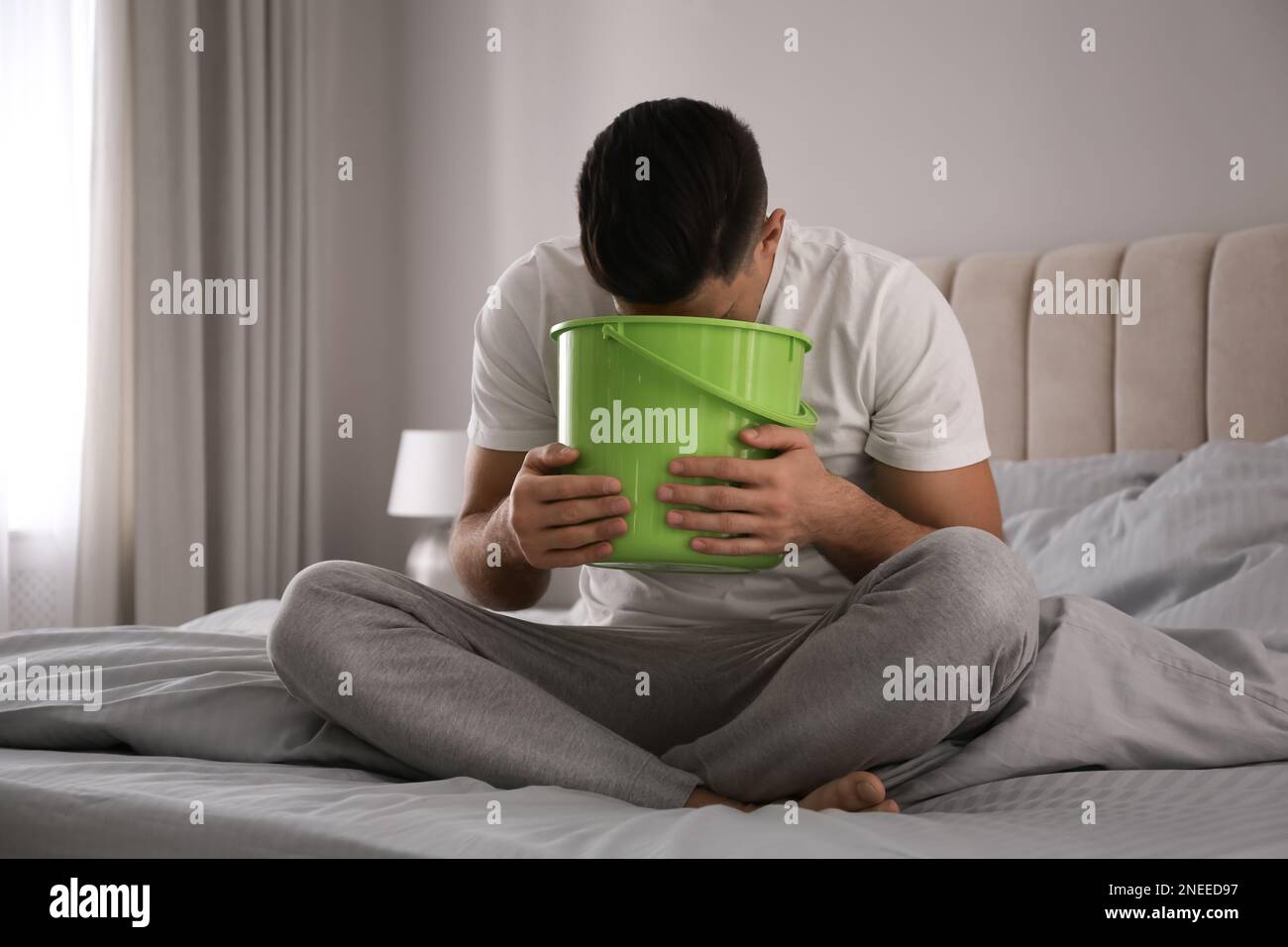 Man vomiting bucket hi-res stock photography and images - Alamy