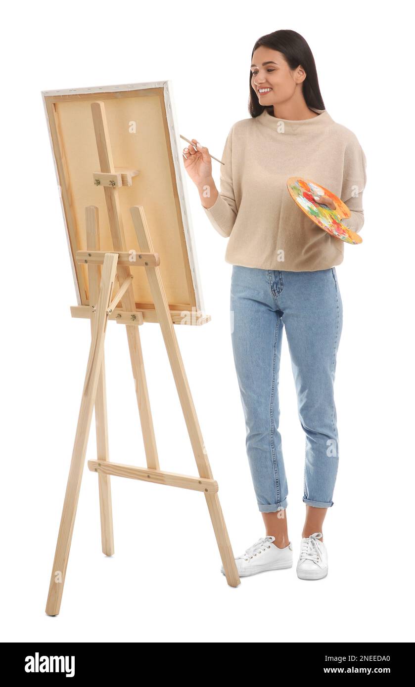Young woman drawing on easel against white background Stock Photo - Alamy