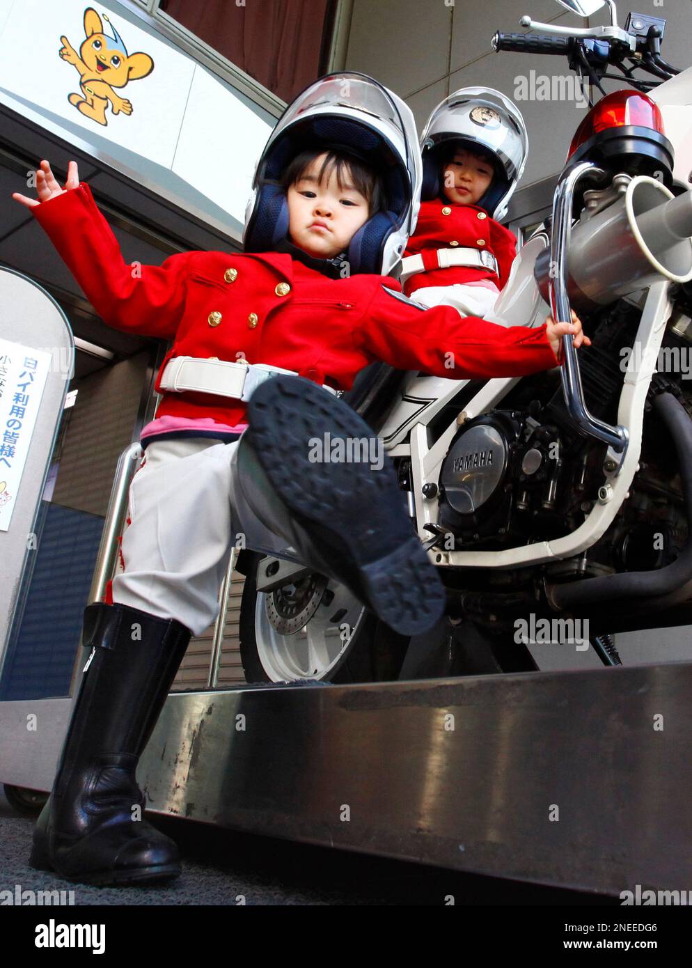 Hanano Kaburagi, 3, and her four-year-old sister Fuka, back, wearing ...