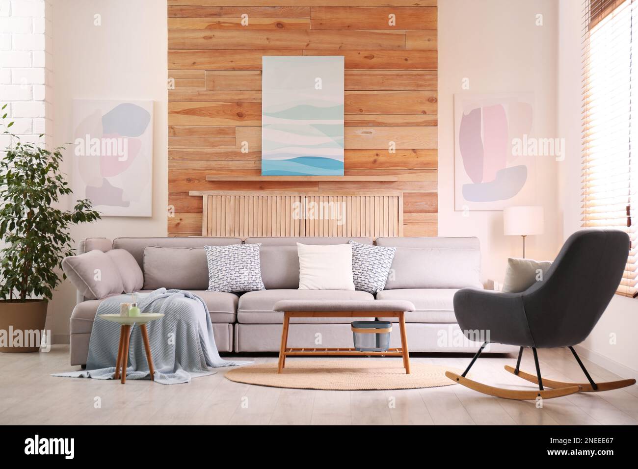 Stylish living room interior with comfortable sofa and pictures Stock ...