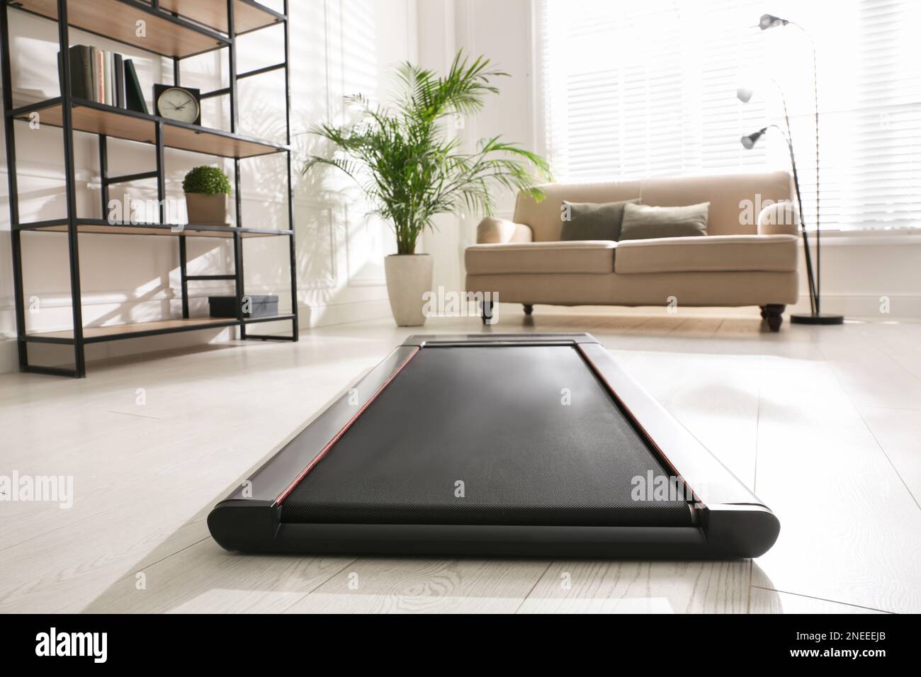 Modern walking treadmill in living room. Home gym equipment Stock Photo ...