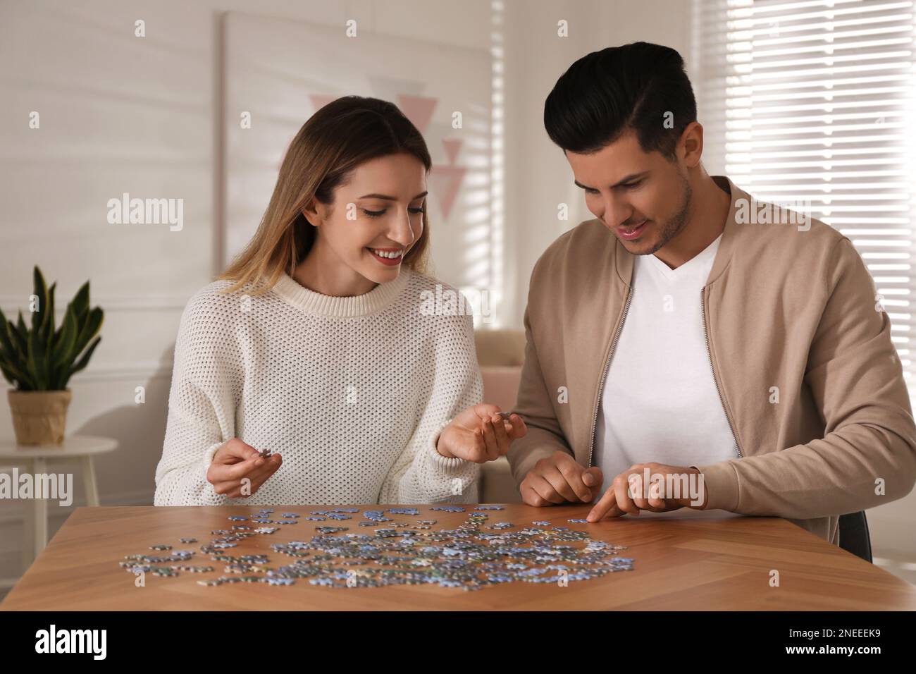 Happy woman playing puzzles hi-res stock photography and images - Alamy