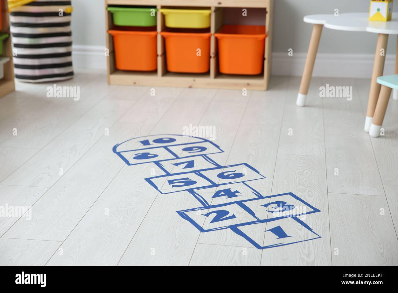 Blue hopscotch floor sticker in playing room Stock Photo - Alamy