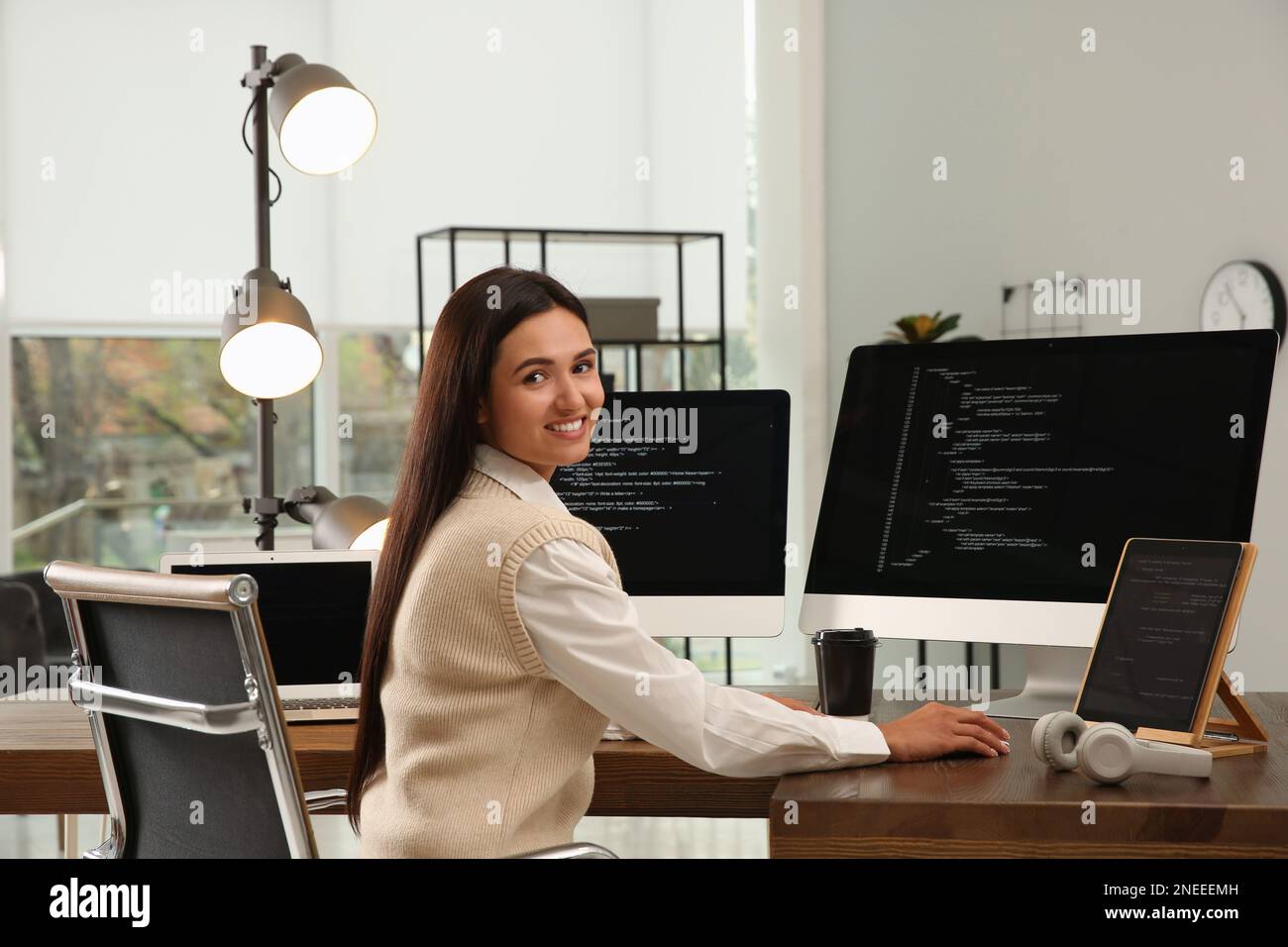 Happy programmer working at desk in office Stock Photo - Alamy