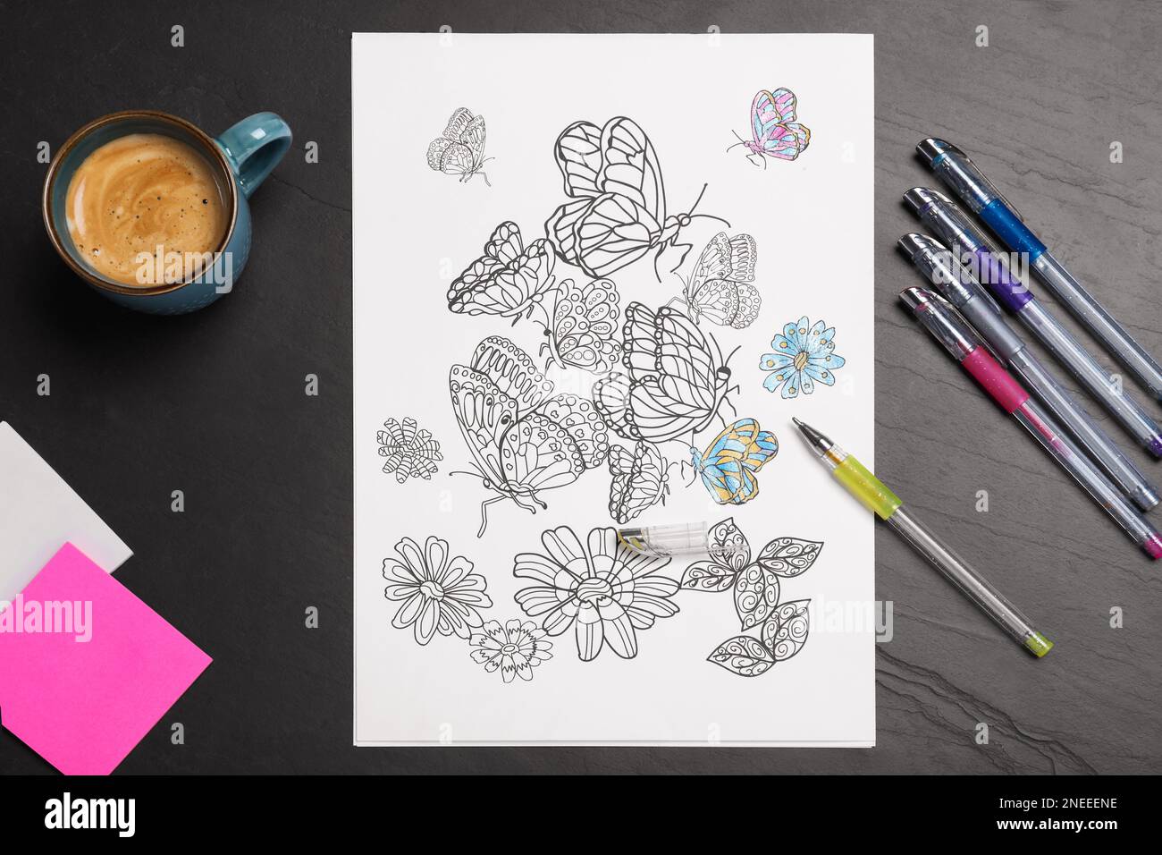 Antistress coloring page, pens and coffee on black table, flat lay ...