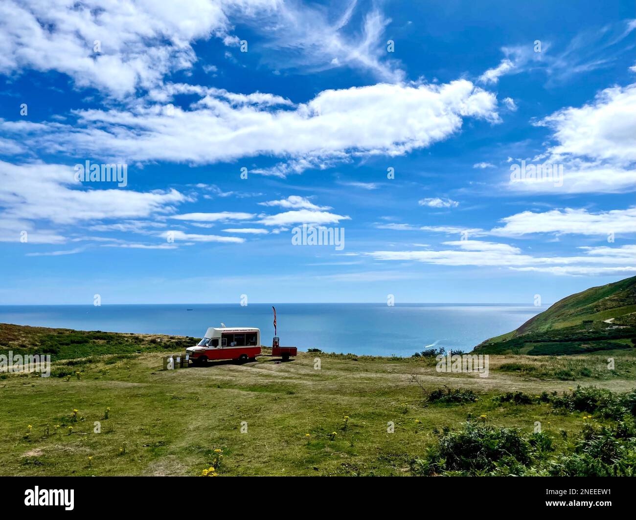 A red and white bray head coffee van on the green coats of the sea in ...