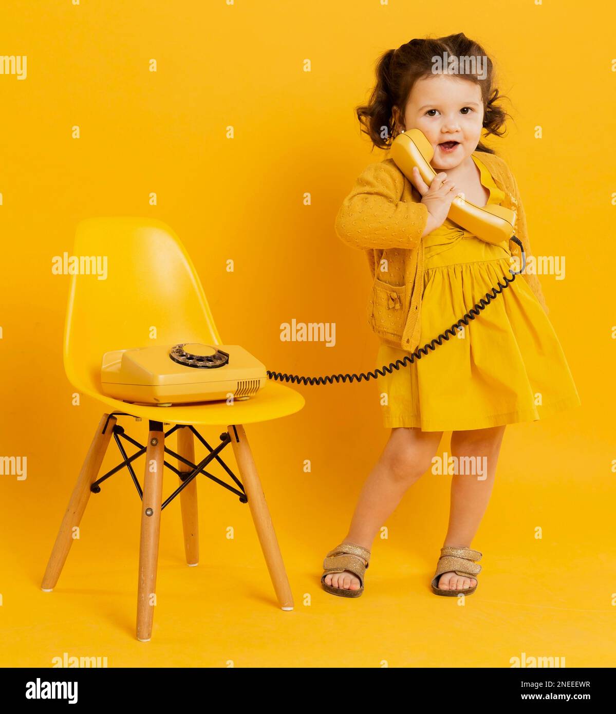 cute child posing while holding telephone Stock Photo - Alamy