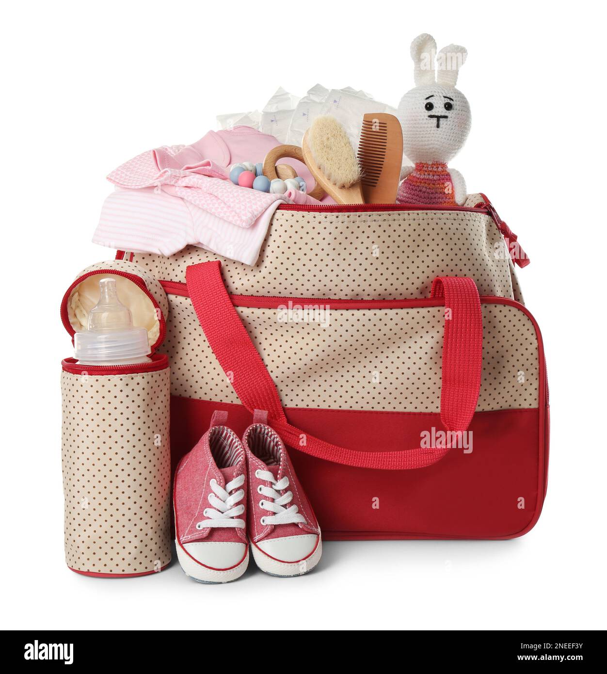 Maternity bag with child's clothes and accessories on white background ...