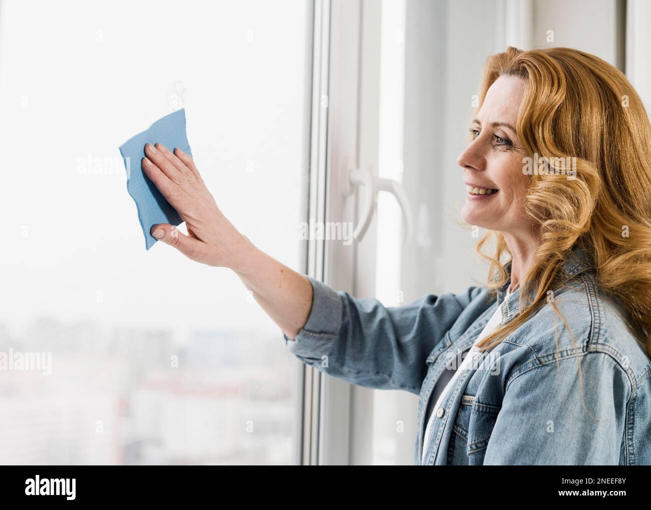 Woman wiping window with rag Stock Photo - Alamy
