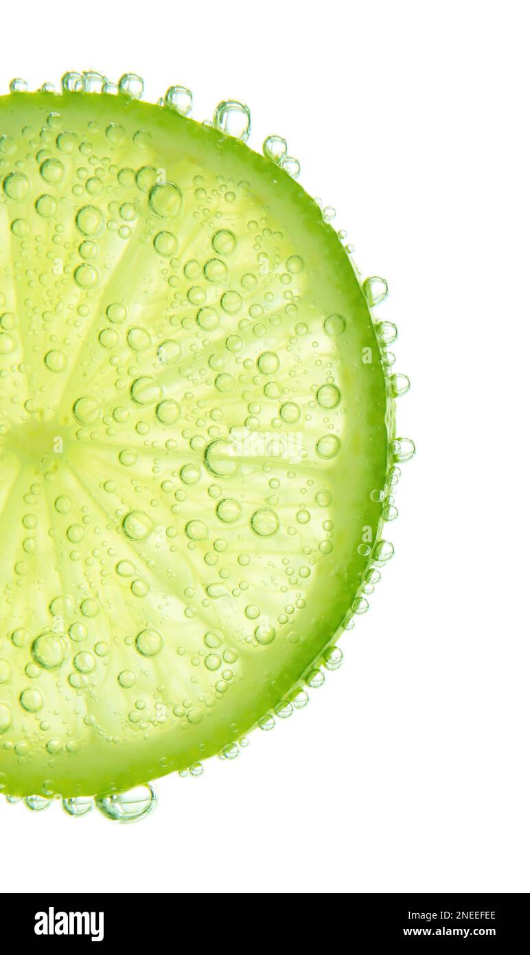 Fresh lime slice in sparkling water on white background Stock Photo - Alamy