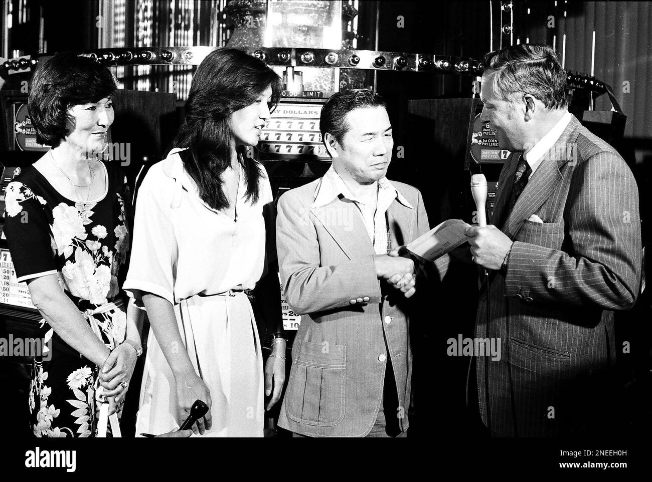 Singer-guitarist Yoshio Tabata of Japan looks at the check just handed ...